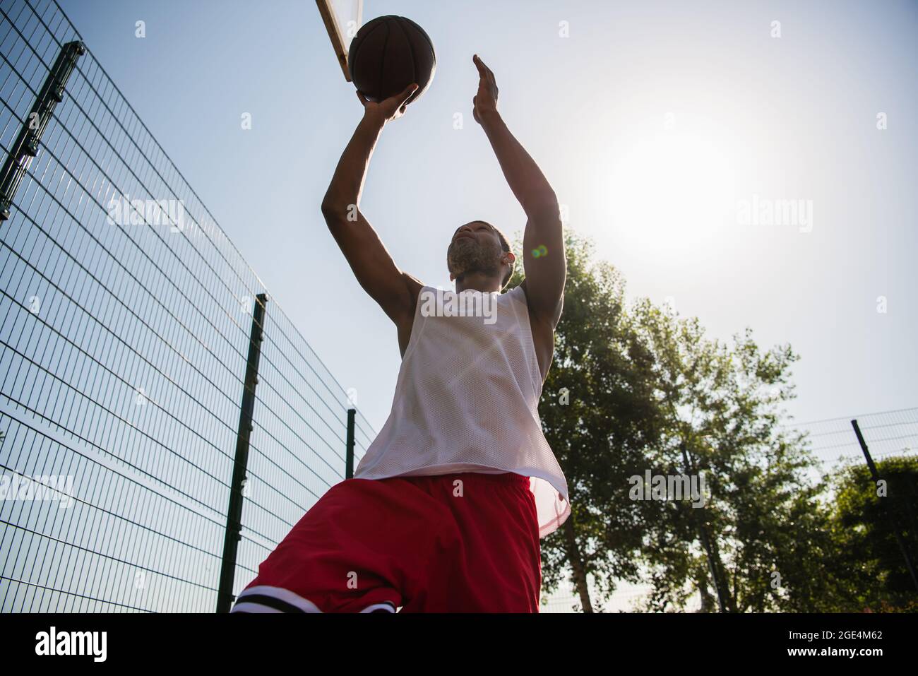 Low angle view sportsman jumping hi-res stock photography and images ...