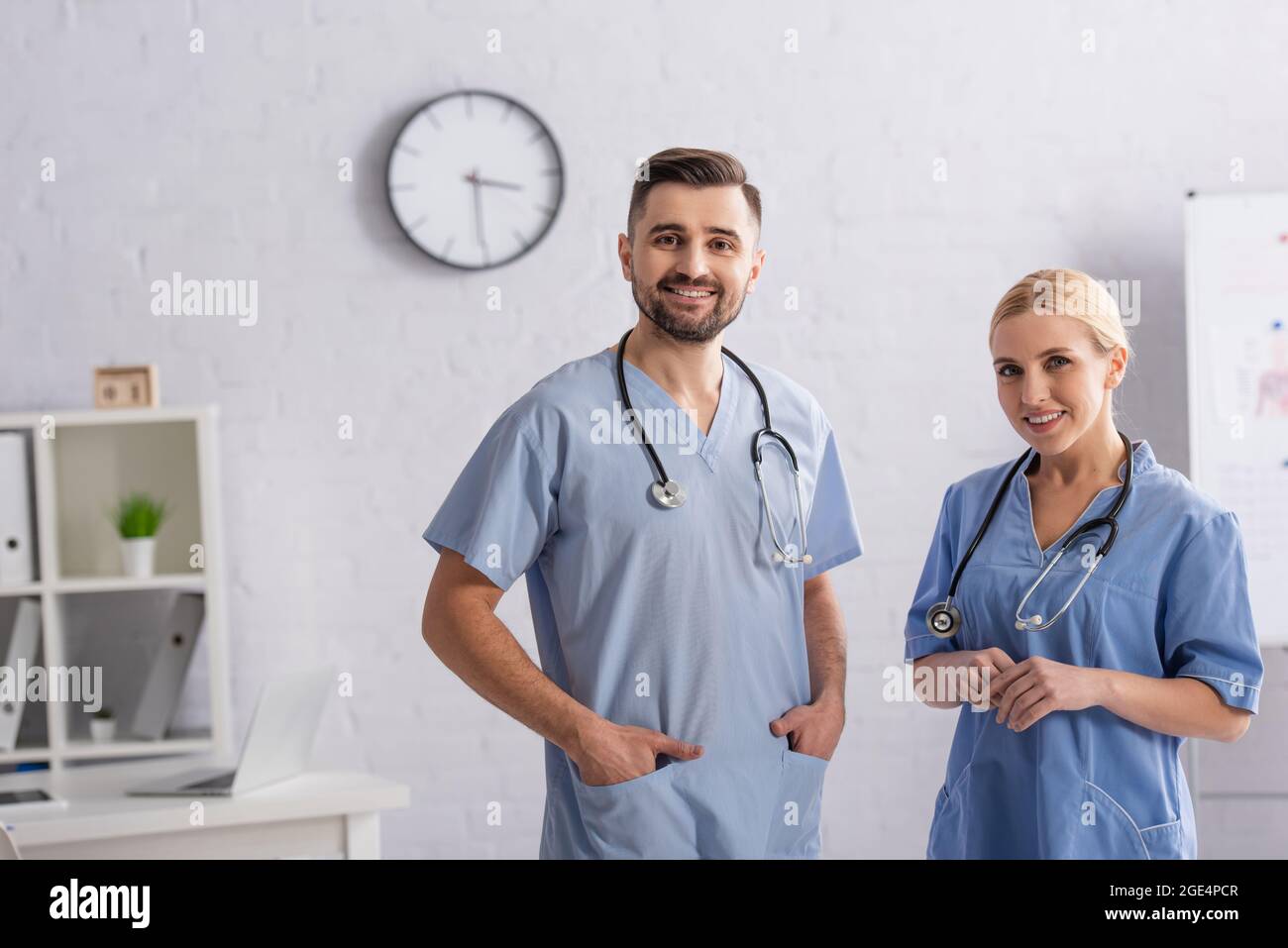 Cheerful doctor standing hands hi-res stock photography and images - Alamy