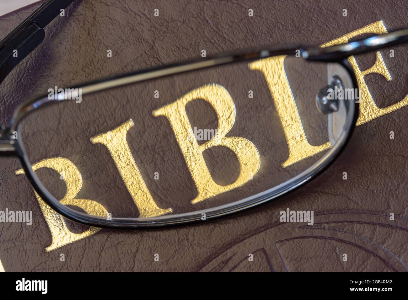 A reading glasses lying on the cover of the Bible, close up Stock Photo ...