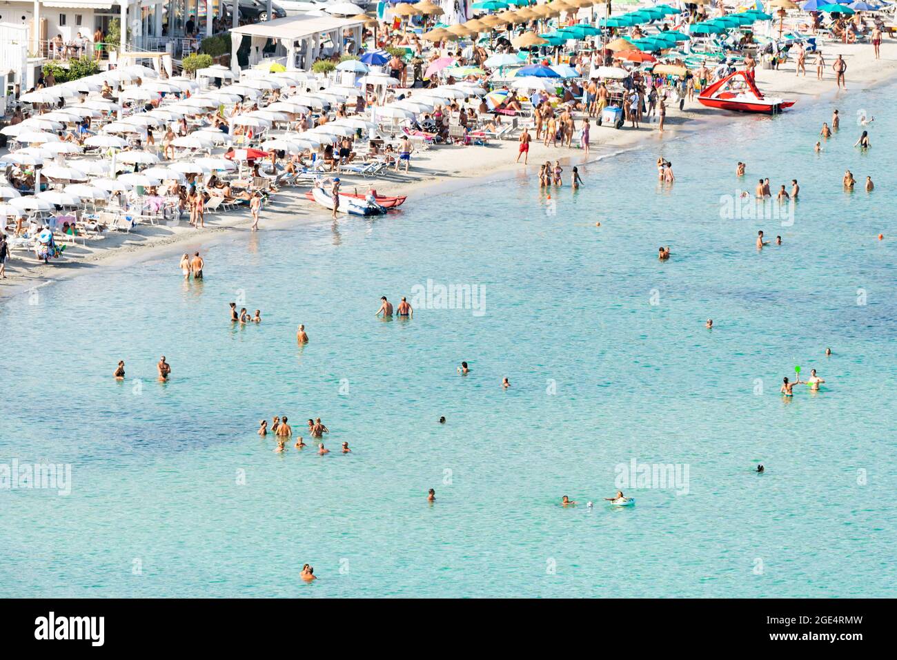 Aerial view of some tourists playing, swimming and sunbathing on a ...