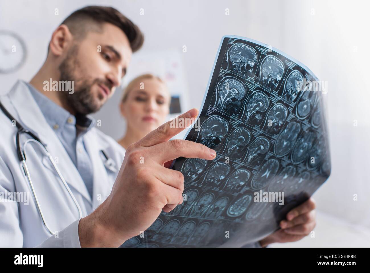 blurred doctor and patient looking at brain mri scan in hospital Stock ...