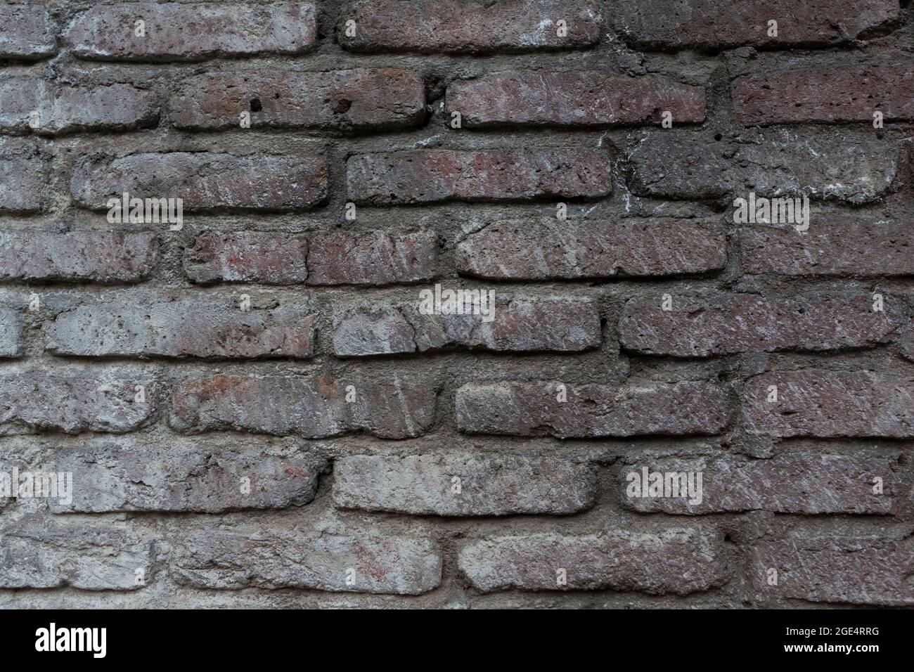 Texture of a wall made of old raw bricks. The walls are deep gray ...