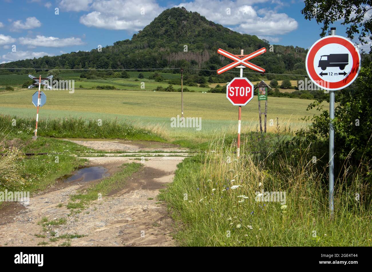 A red STOP sign before crossing the tracks, Czech Central Highlands ...