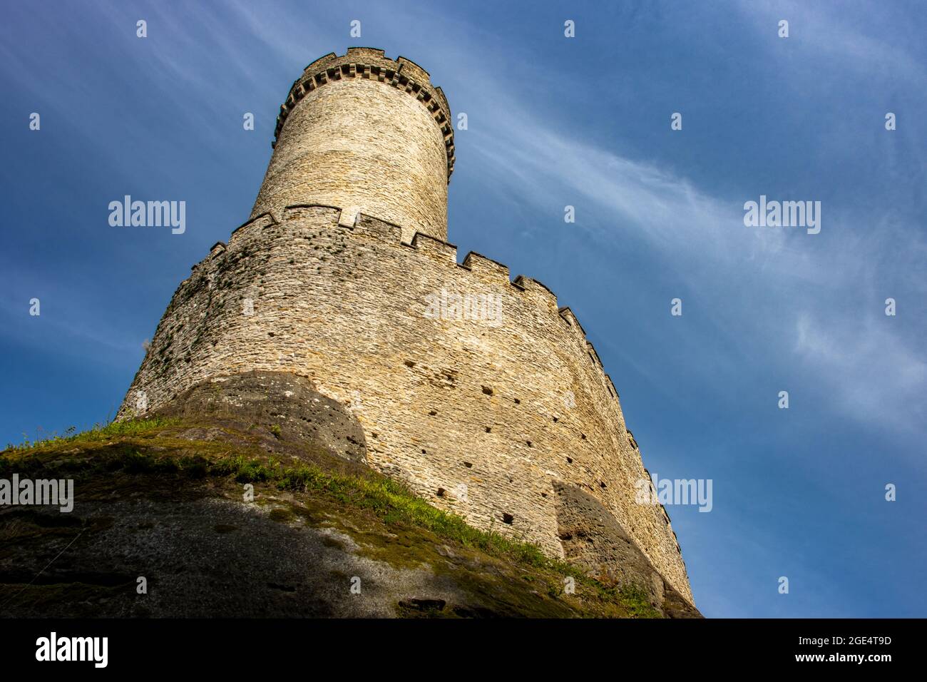 A circular stone tower behind the walls with the battlements of a ...