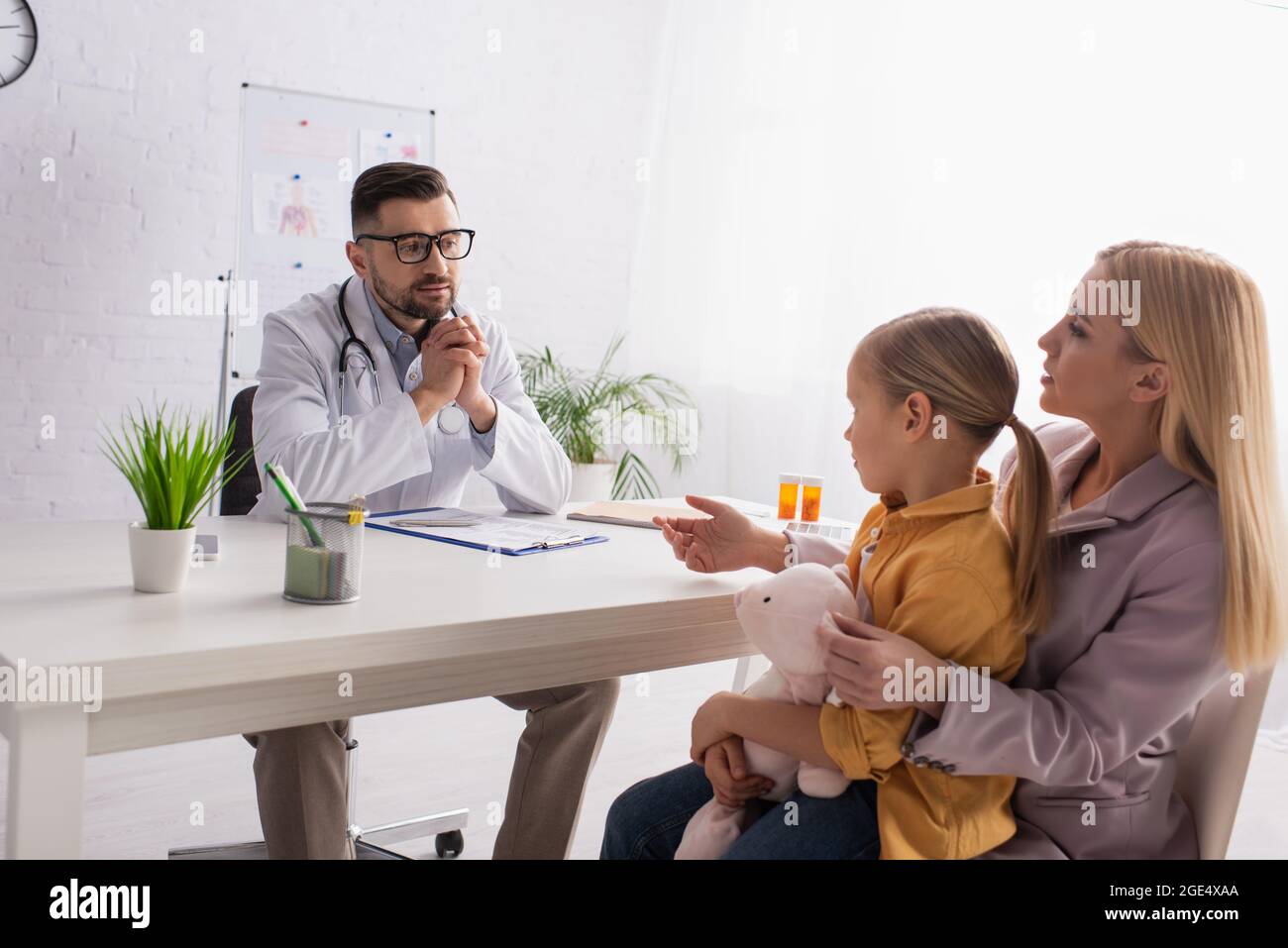 woman with child talking to family doctor during consultation Stock ...