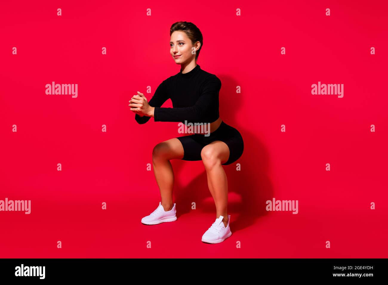 Portrait of attractive focused strong sportive flexible girl doing sit ...