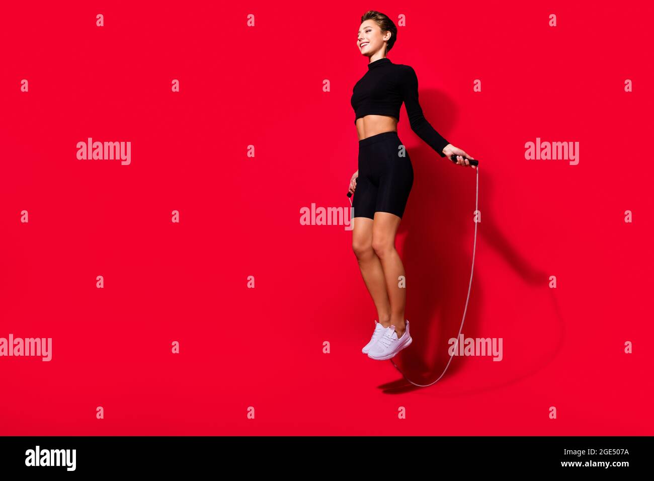 Profile photo of sporty energetic lovely lady jump skipping rope wear ...