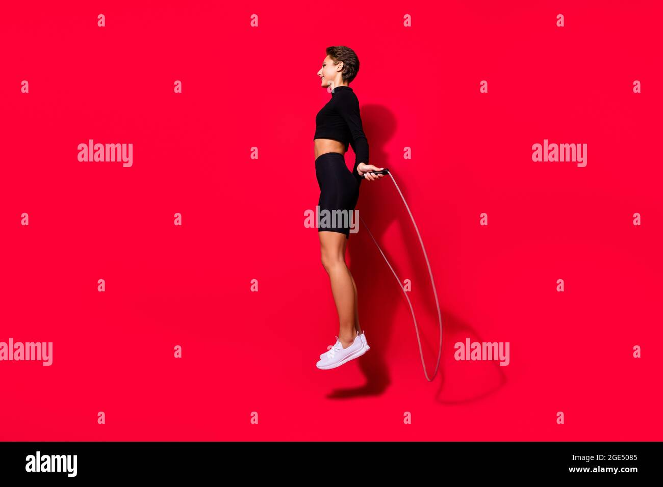 Profile photo of active cute lady jump skipping rope wear black cropped ...