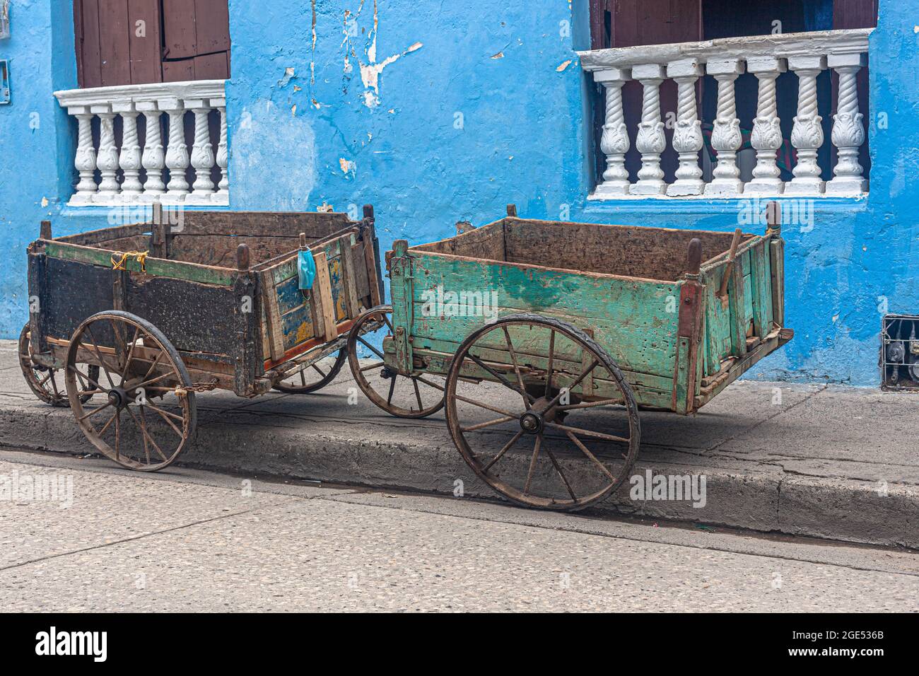 Old colourful carts parked on the pavement, Cartagena de Indias ...