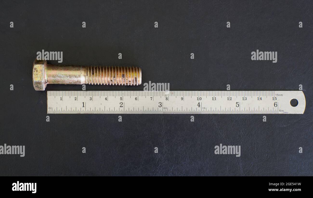 A Ruler and Bolt on a Black Background Stock Photo - Alamy