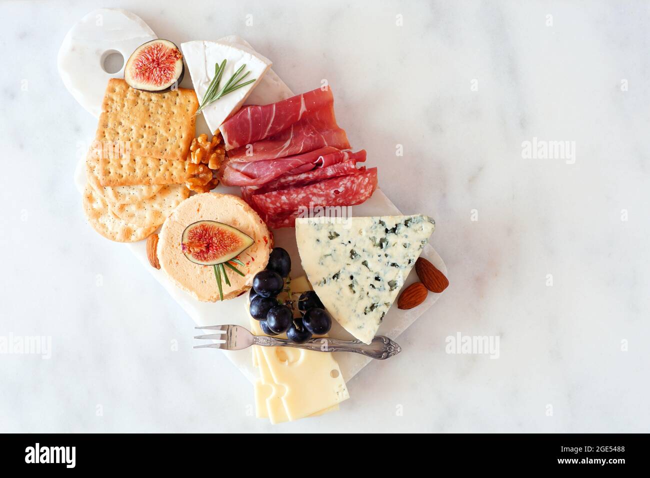Appetizer platter with assorted cheeses and cold cut meats. Top view on ...