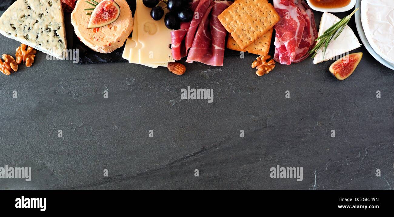 Assorted cheeses and deli meat appetizers. Top border, above view ...