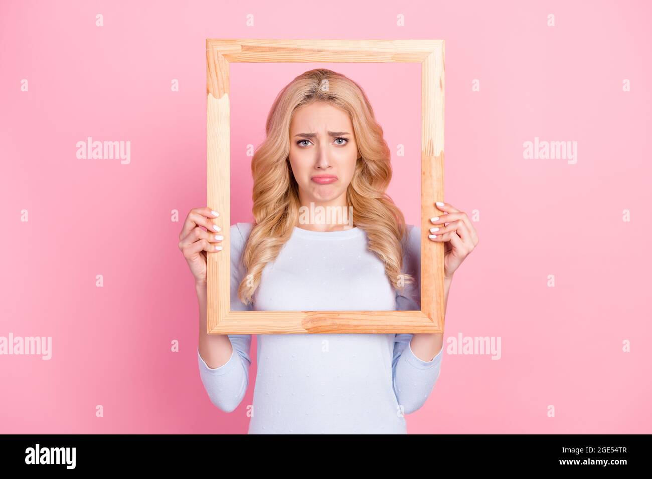Photo of unhappy upset lady hold hands wooden frame bad mood isolated ...