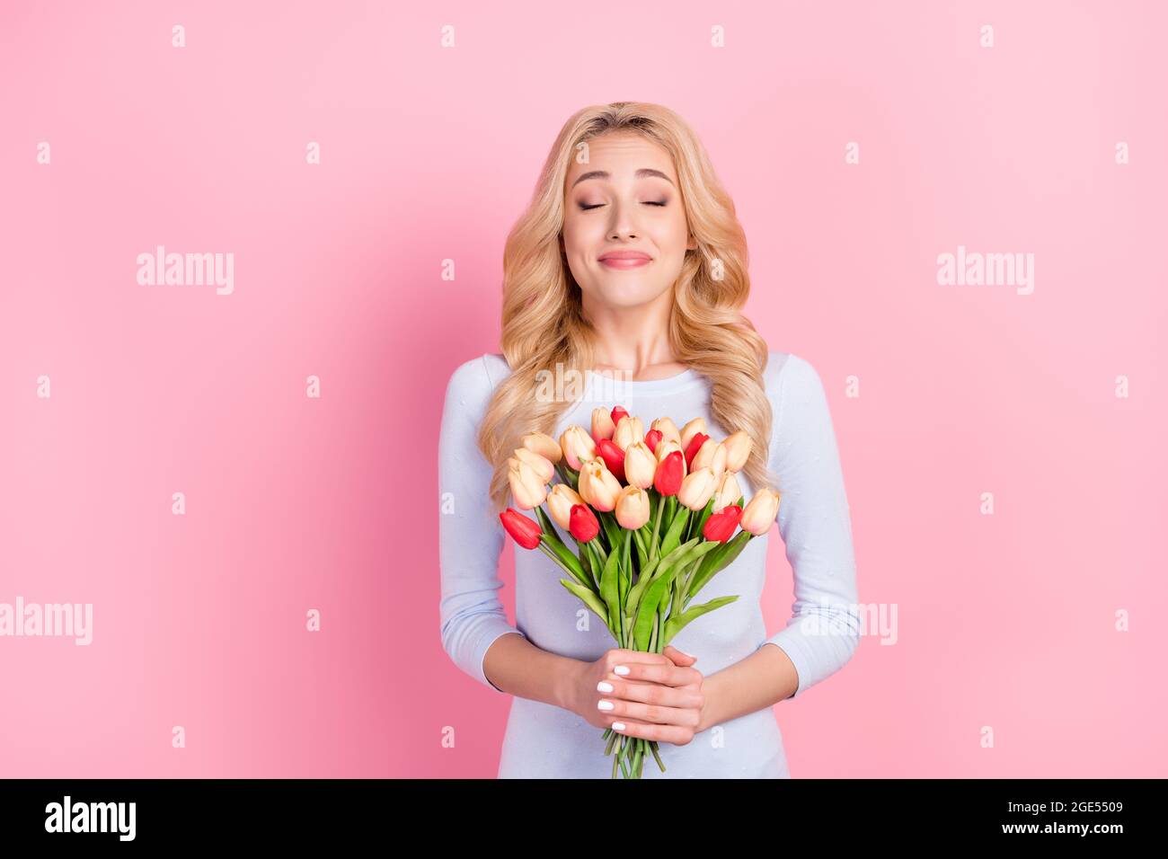 Photo of attractive flirty young woman hold hands flowers dreamy face ...