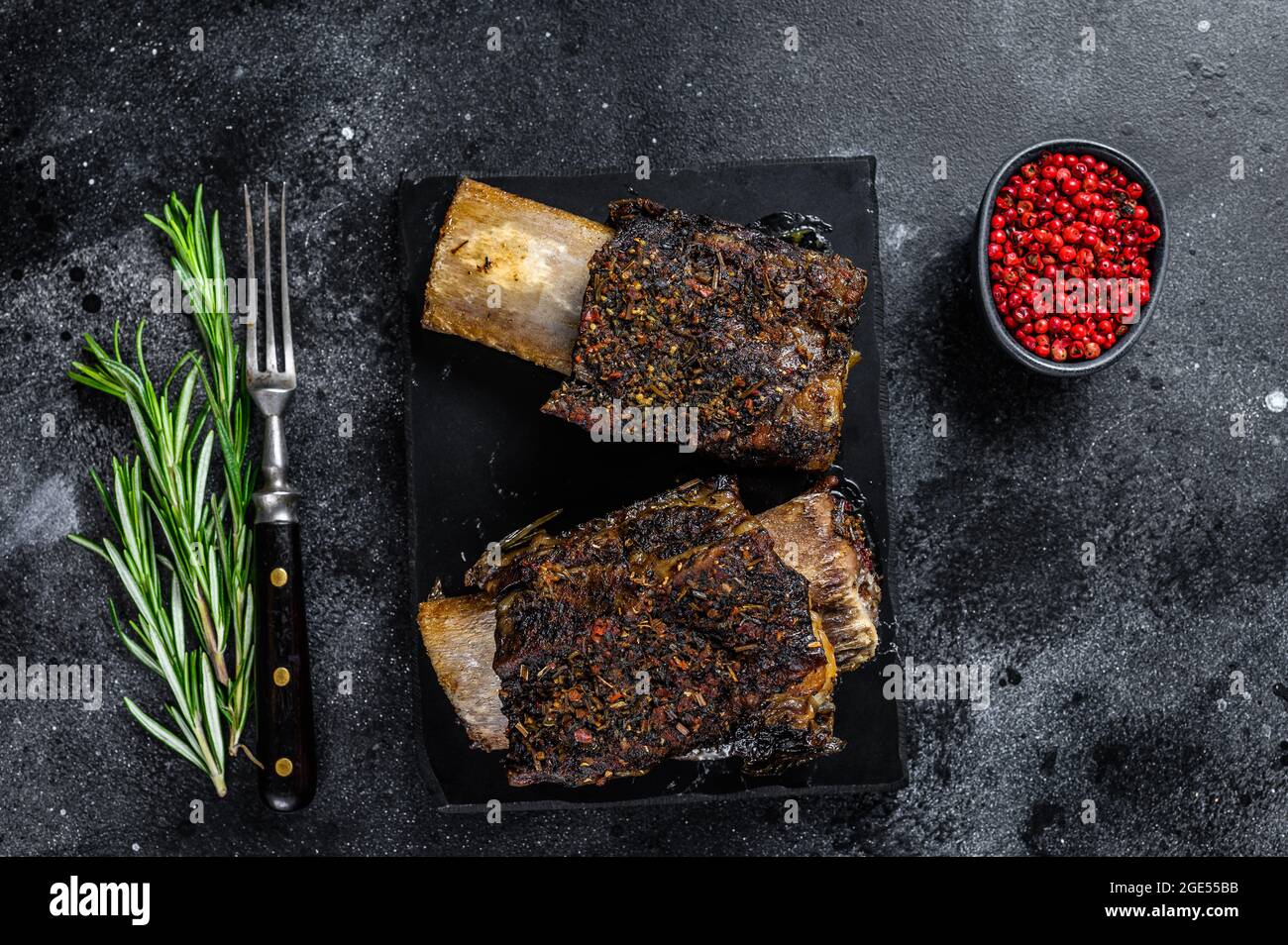 BBQ Beef Short Ribs with herbs. Black background. Top view Stock Photo ...