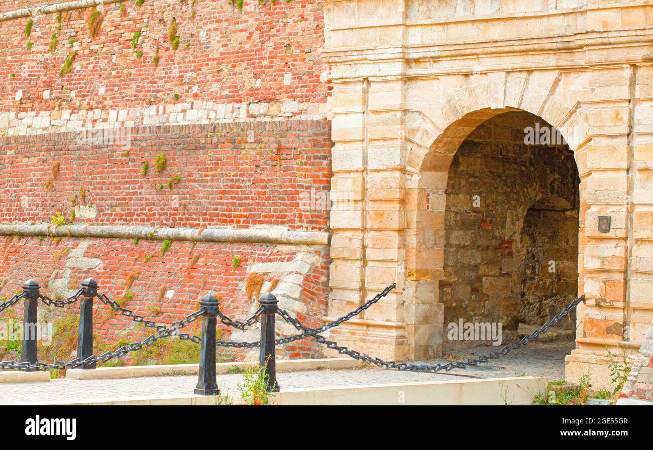 entrance to a stone castle with a large gate through a chain bridge ...