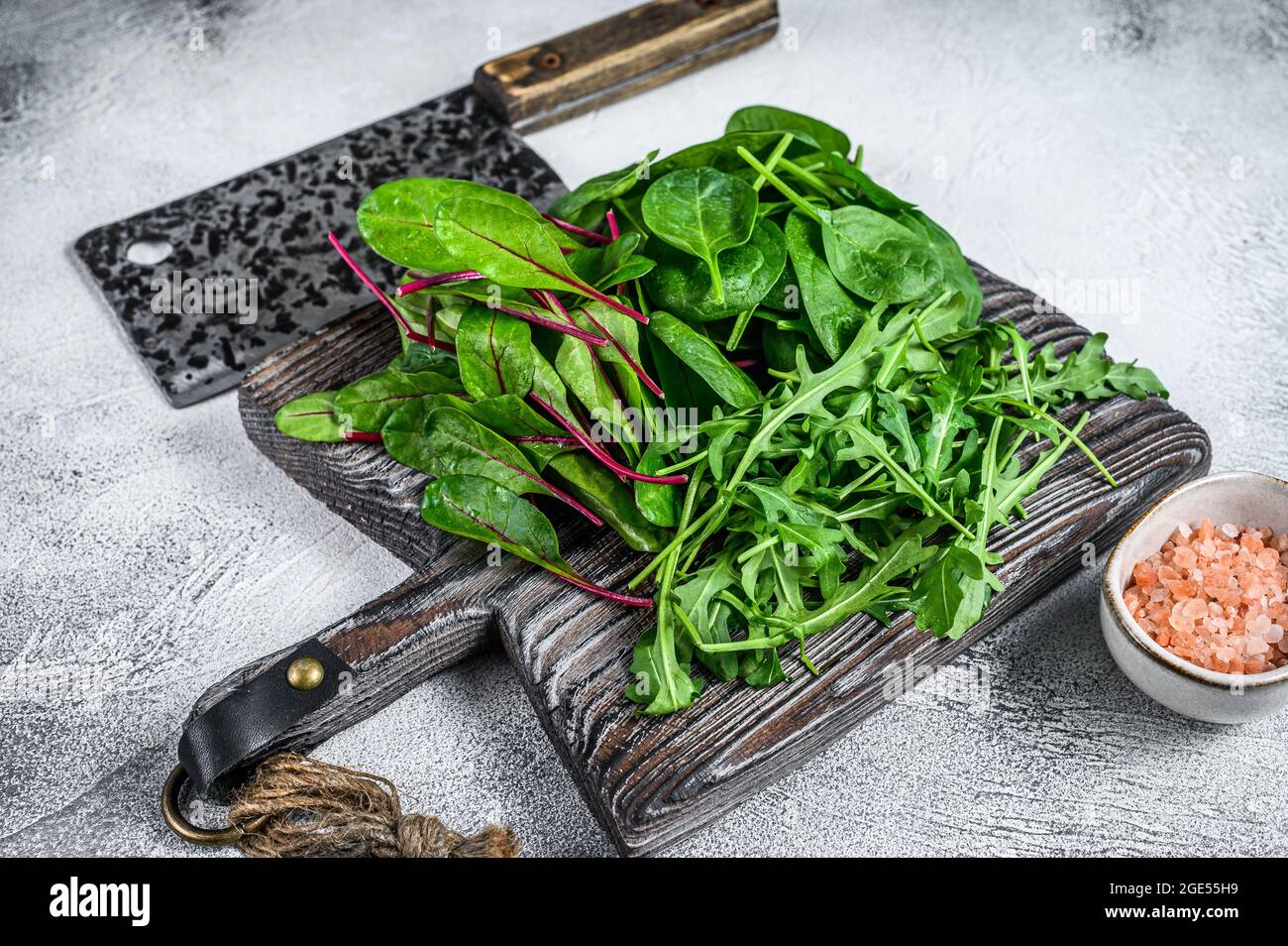 Fresh mixed greens, spinach, swiss chard and arugula. White background ...