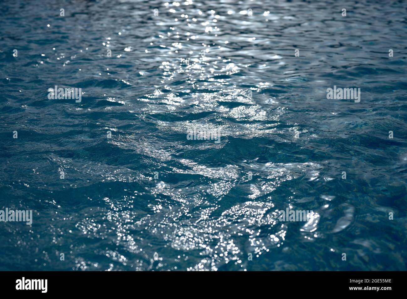 detail of the reflection of sunlight on the water in a swimming pool ...