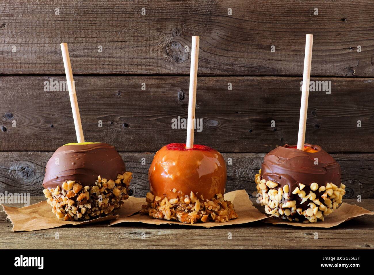 Three types of fall candy apples with chocolate and caramel, side view ...