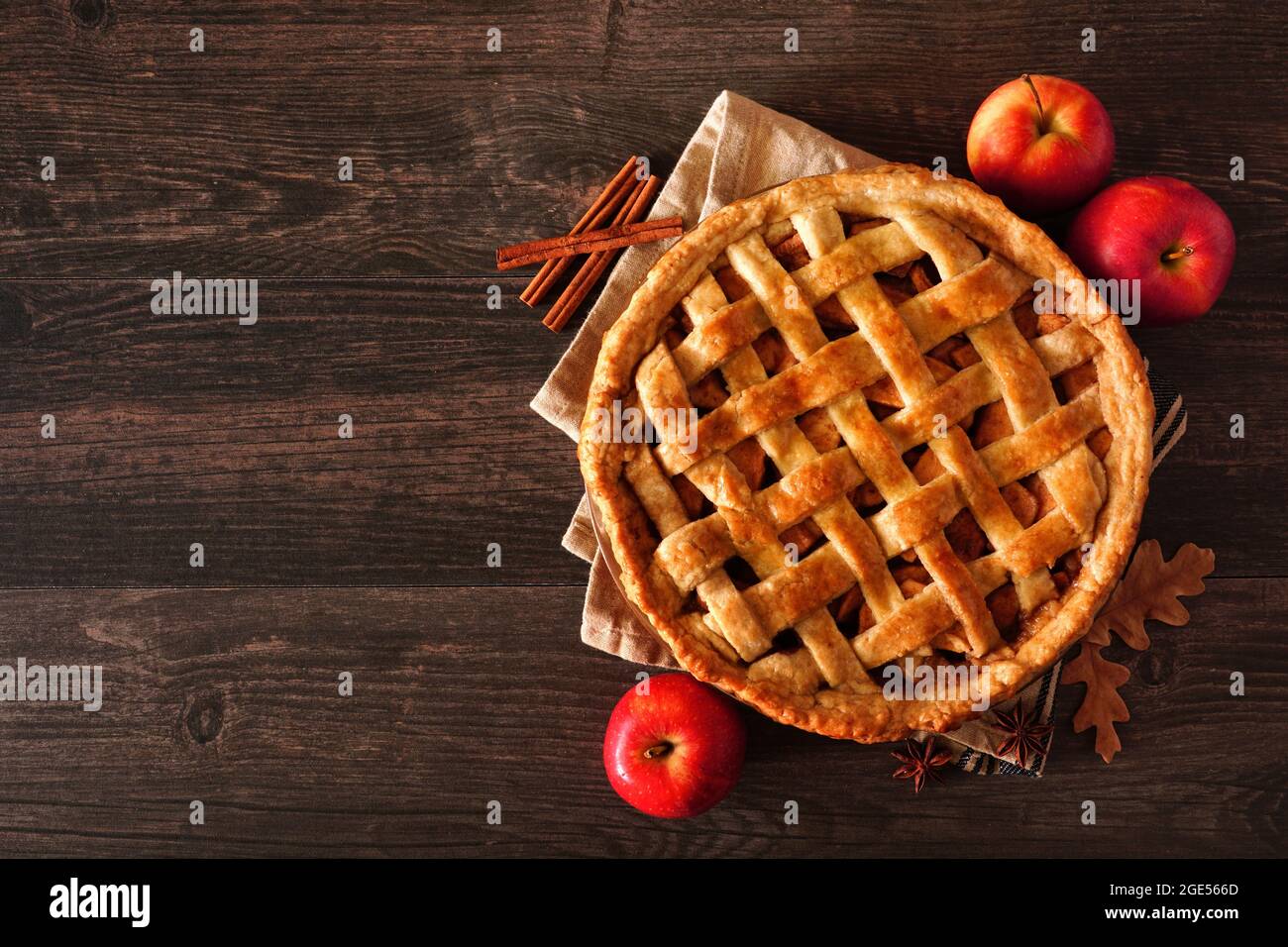 Homemade autumn apple pie, top view with frame of ingredients on a dark ...