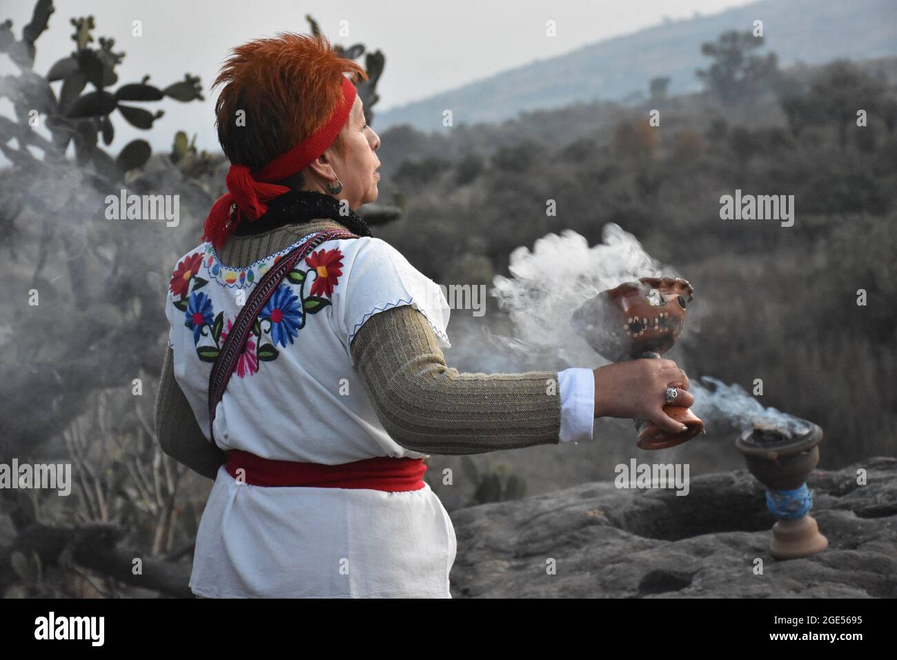 An indigenous shaman performs a ritual to the four cardinal points ...