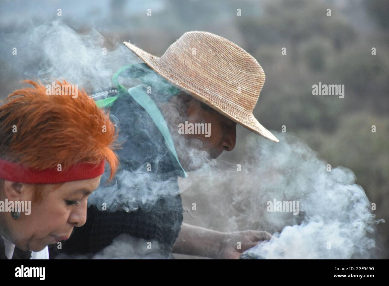 Indigenous people purify themselves with incense at the start of a ...