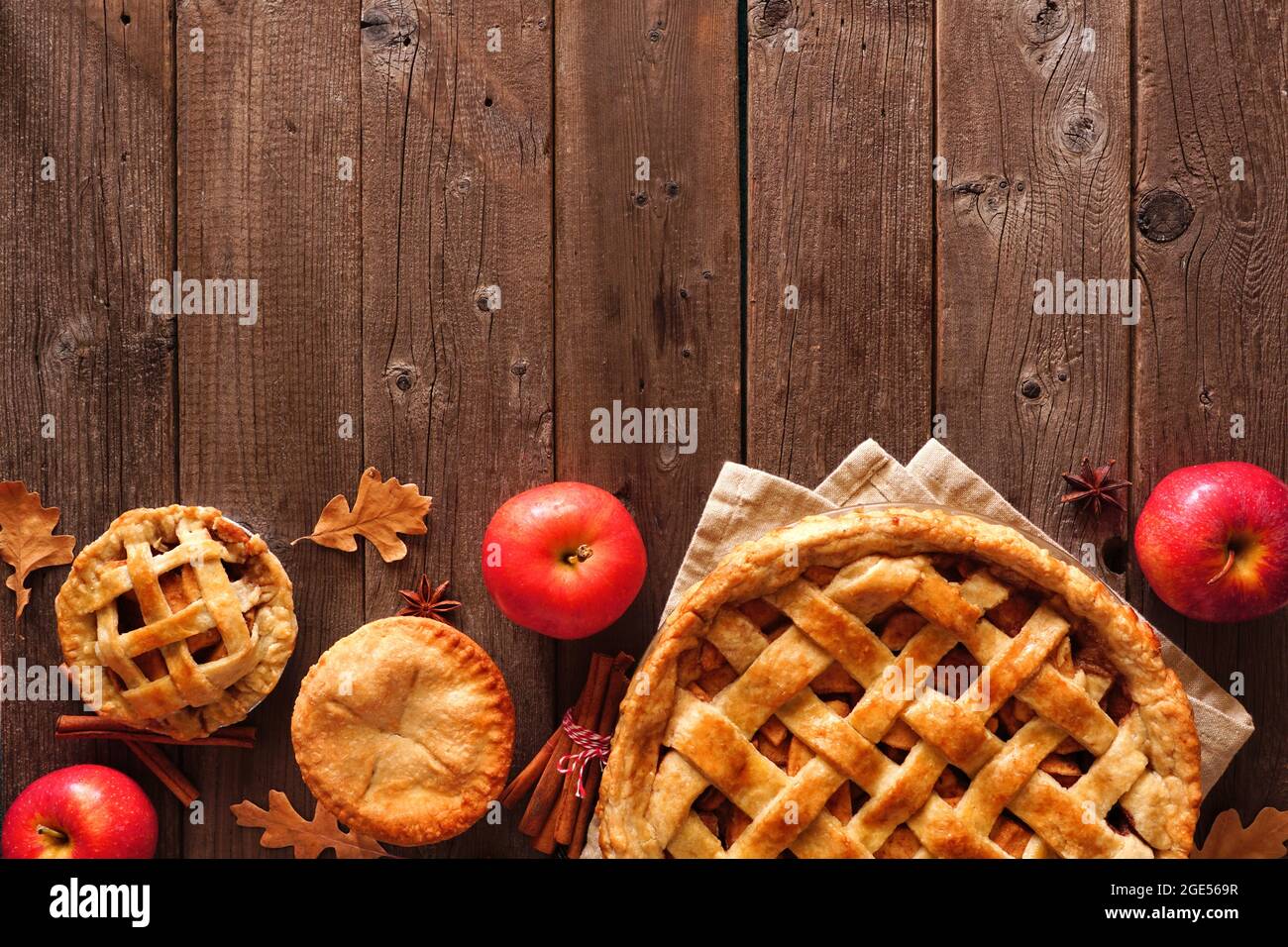 Homemade autumn apple pie bottom border. Above view table scene over a ...