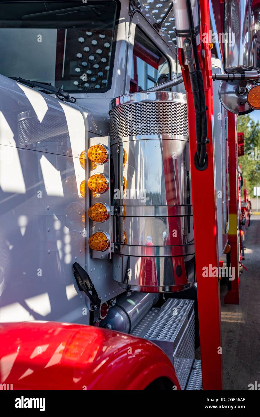 Shiny red and white classic powerful industrial big rig car hauler semi ...