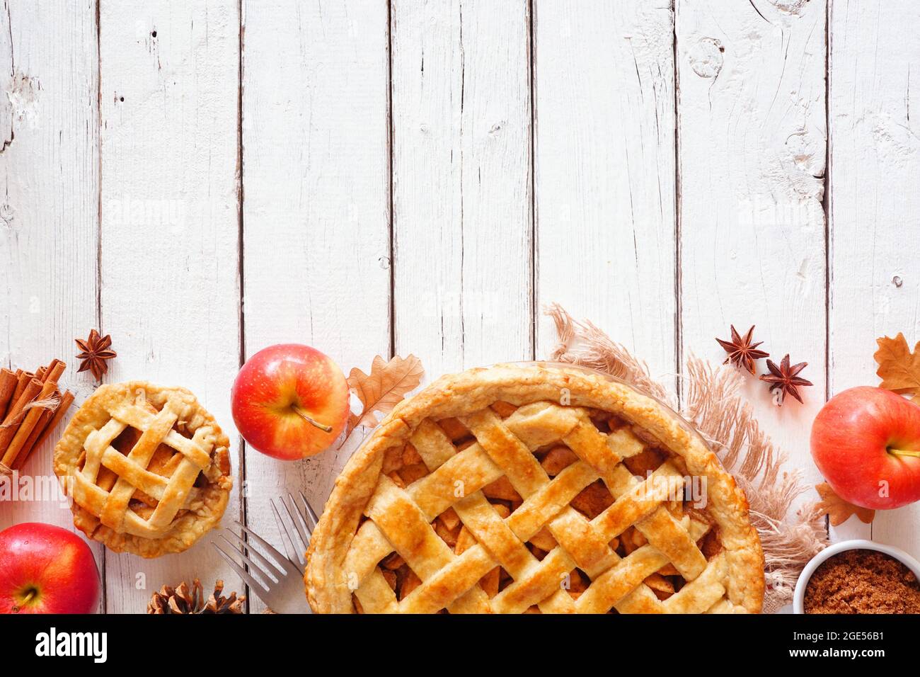Homemade autumn apple pie bottom border. Top view table scene over a ...