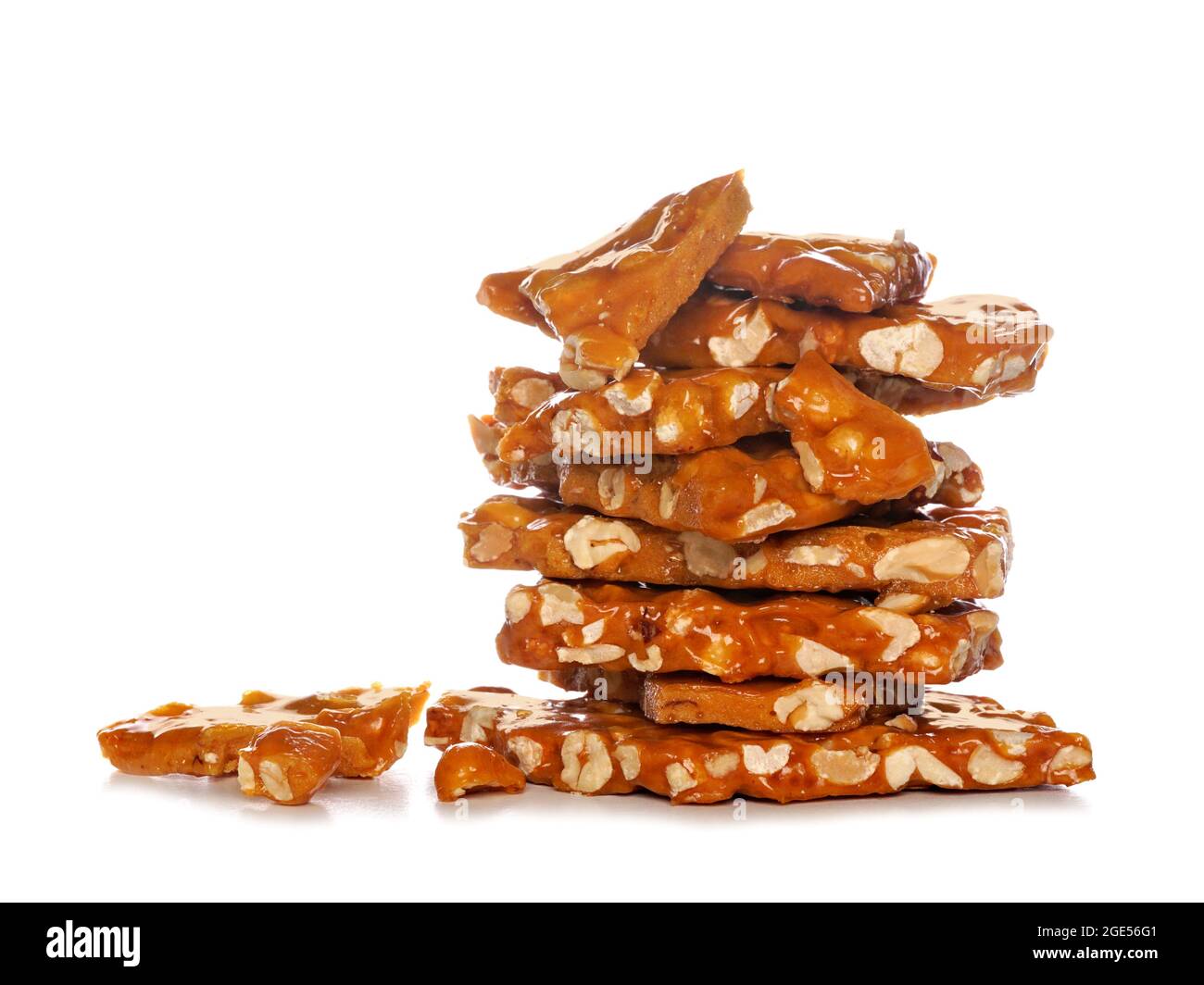 Stack of traditional peanut brittle candy pieces, isolated on a white ...