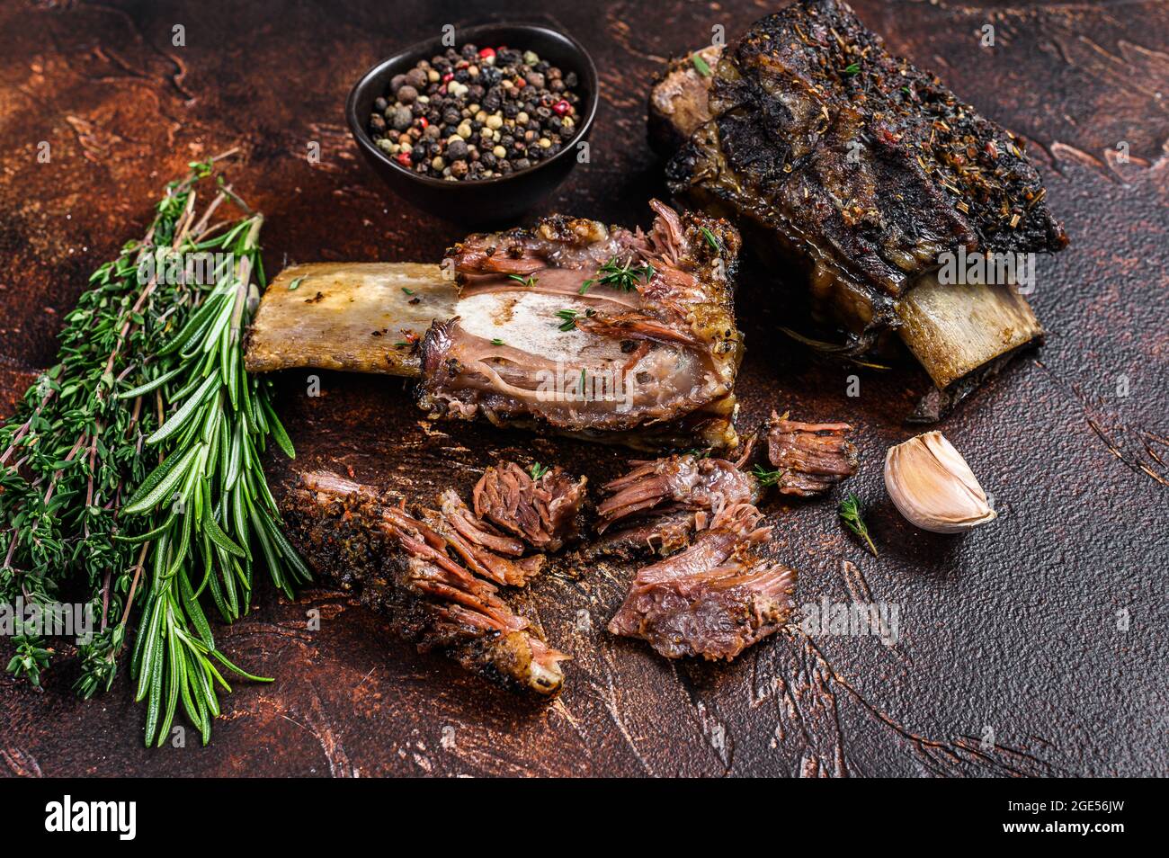 BBQ Grilled short beef ribs on a kitchen table. Dark background. Top ...