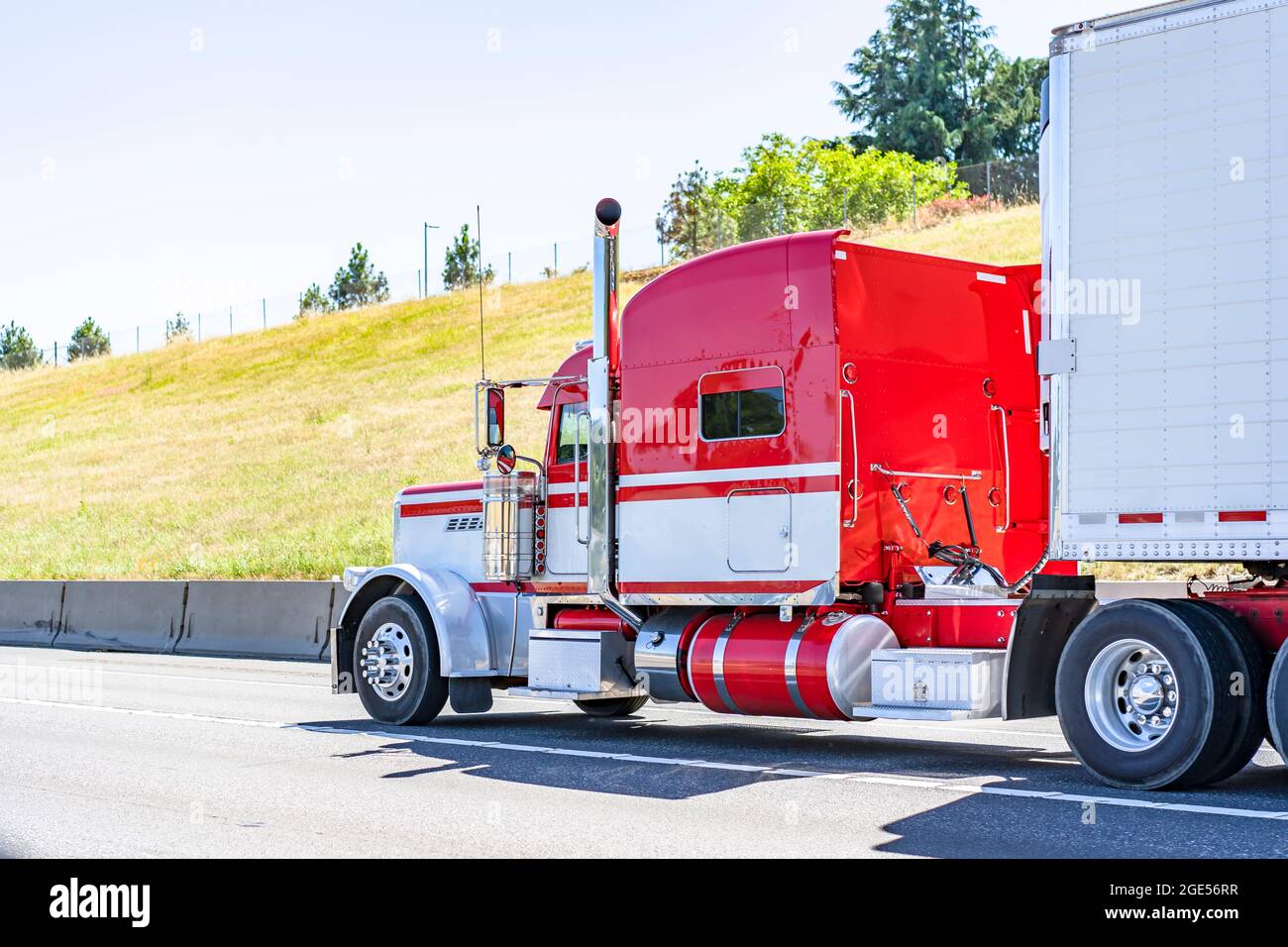 Red and white big rig long haul classic American semi truck with chrome ...