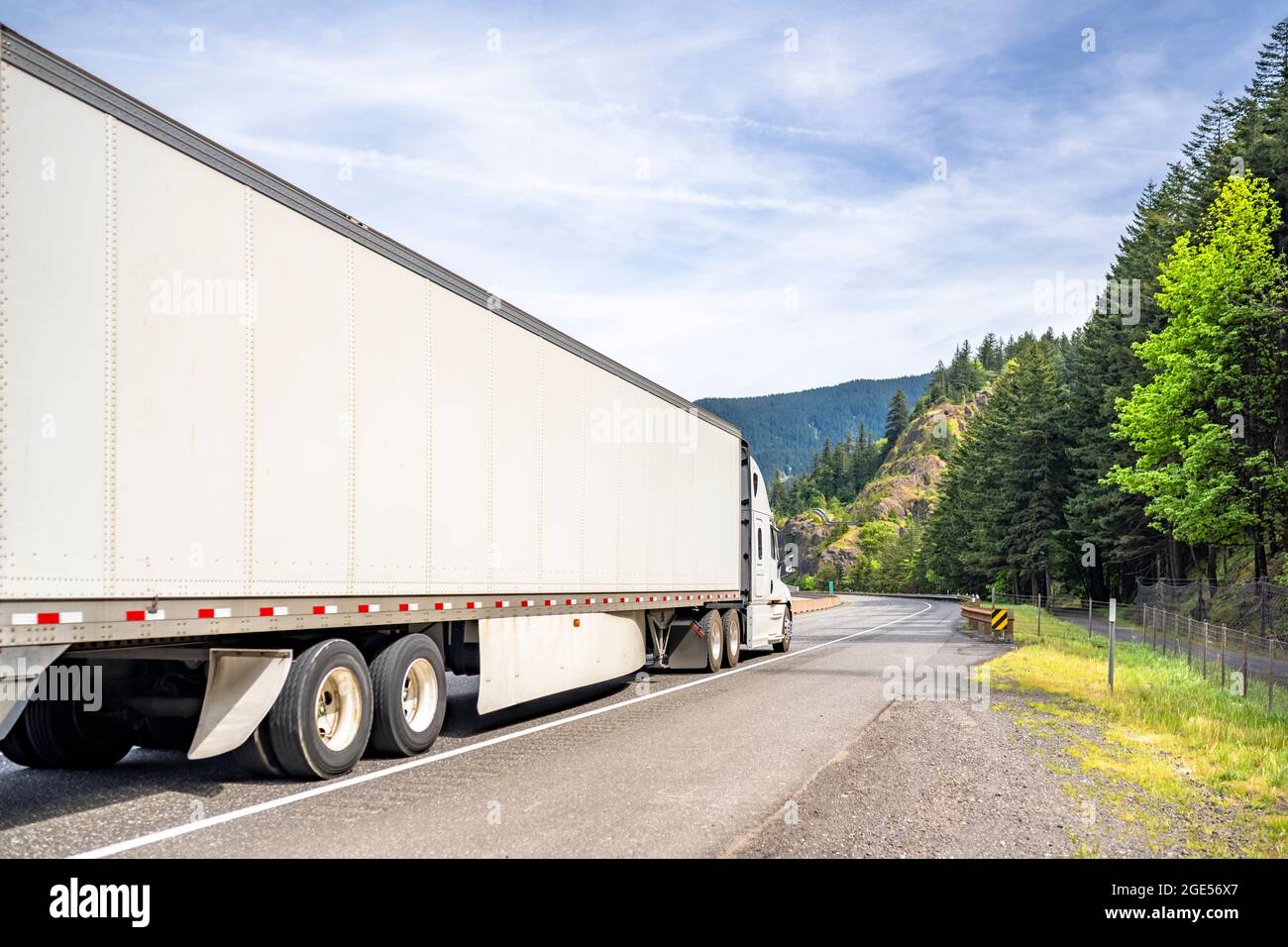 Industrial long hauler big rig white semi truck tractor transporting ...