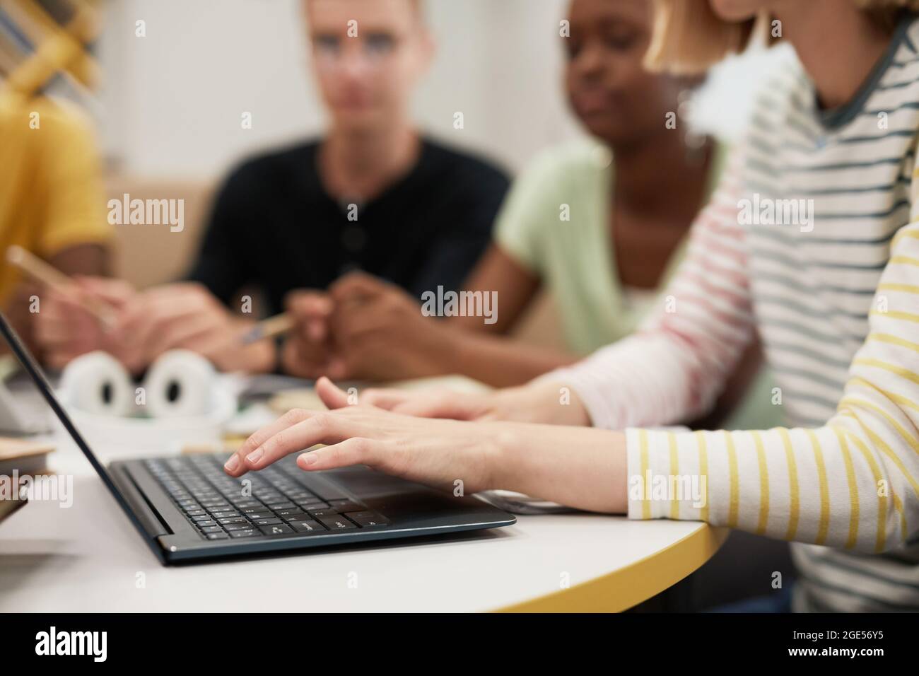 Side view close up at diverse group of young people studying together ...