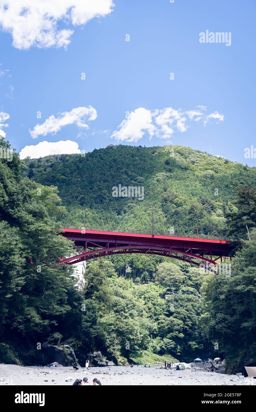 Okuma red bridge summer season in Japan. camping placed Stock Photo - Alamy