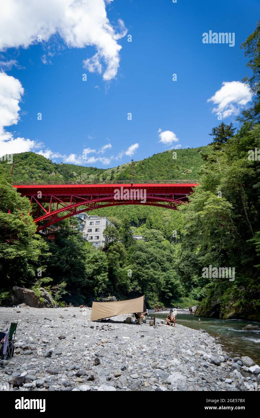 Okuma red bridge summer season in Japan. camping placed Stock Photo - Alamy
