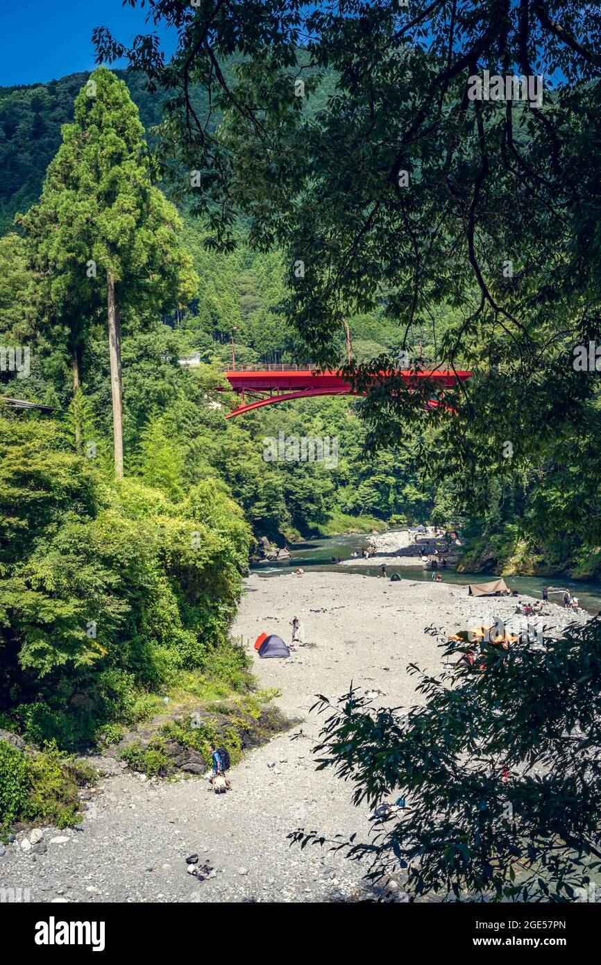 Okuma red bridge summer season in Japan. camping placed Stock Photo - Alamy