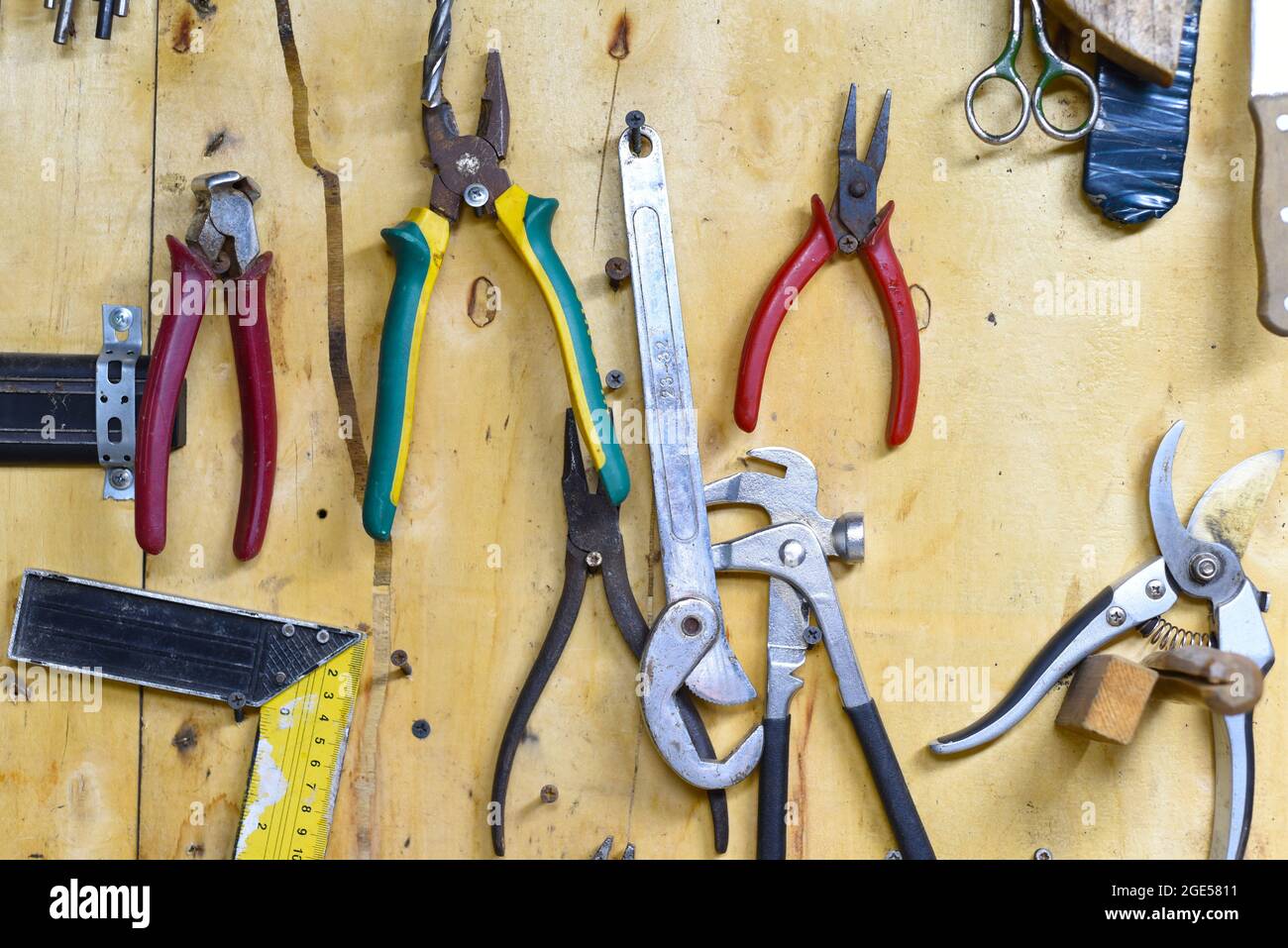 Tools hanging on wooden wall Stock Photo - Alamy