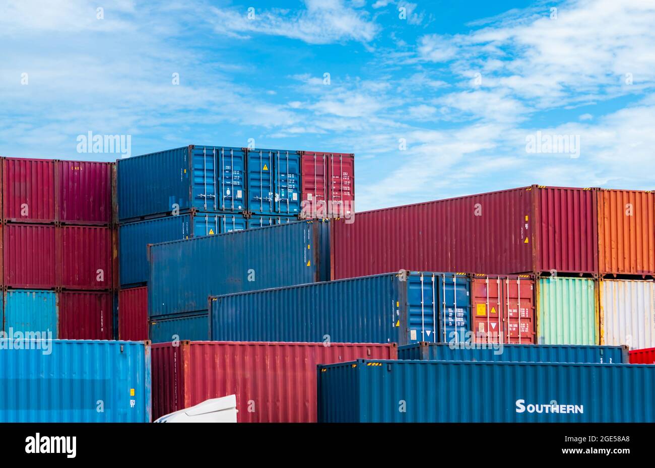 Red and blue logistic container against blue sky. Cargo and shipping ...