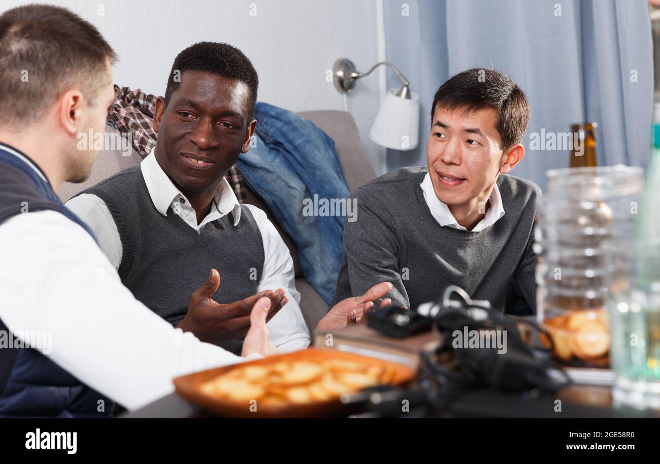Three friends are talking about life together Stock Photo - Alamy