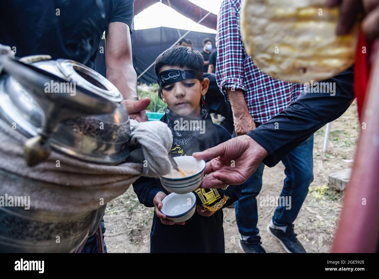 Srinagar, India. 16th Aug, 2021. A Kashmiri Shia boy looks on as he ...