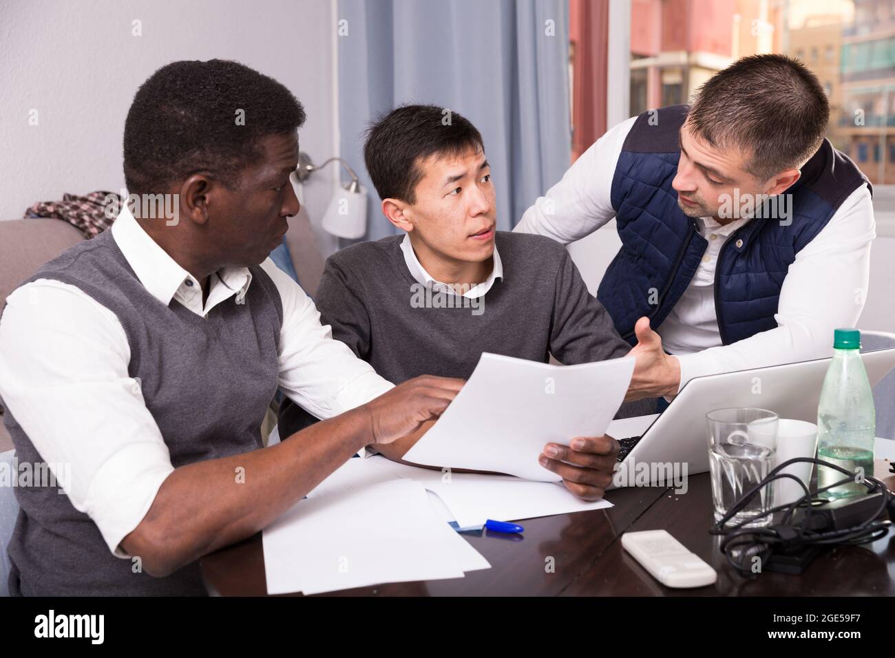 Serious men with documents at home Stock Photo - Alamy