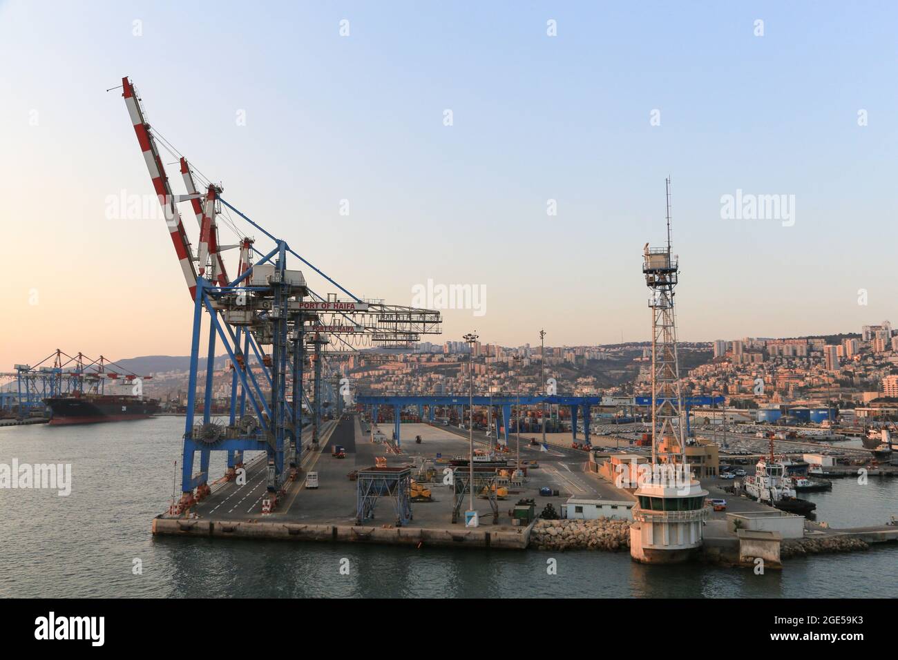 Gantry cranes and shipping containers line the pier at the Port of ...