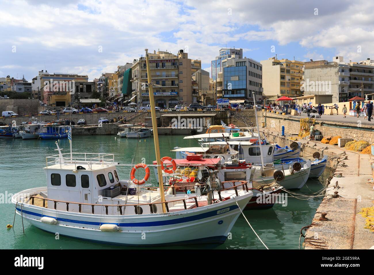 Fishing boats line the stone quay at the Venetian Harbour of Heraklion ...