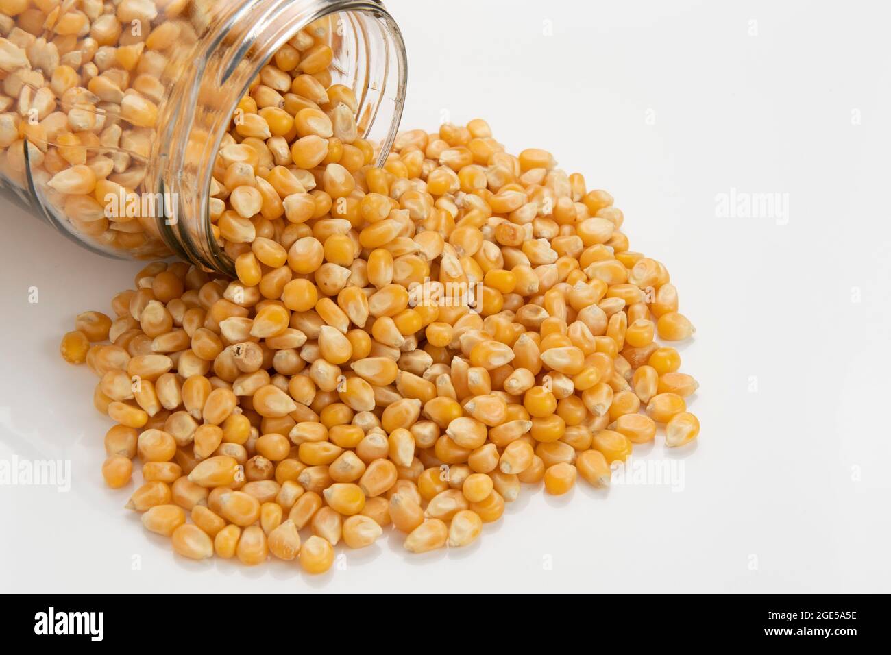 glass pot with popcorn pouring out in a white background Stock Photo ...
