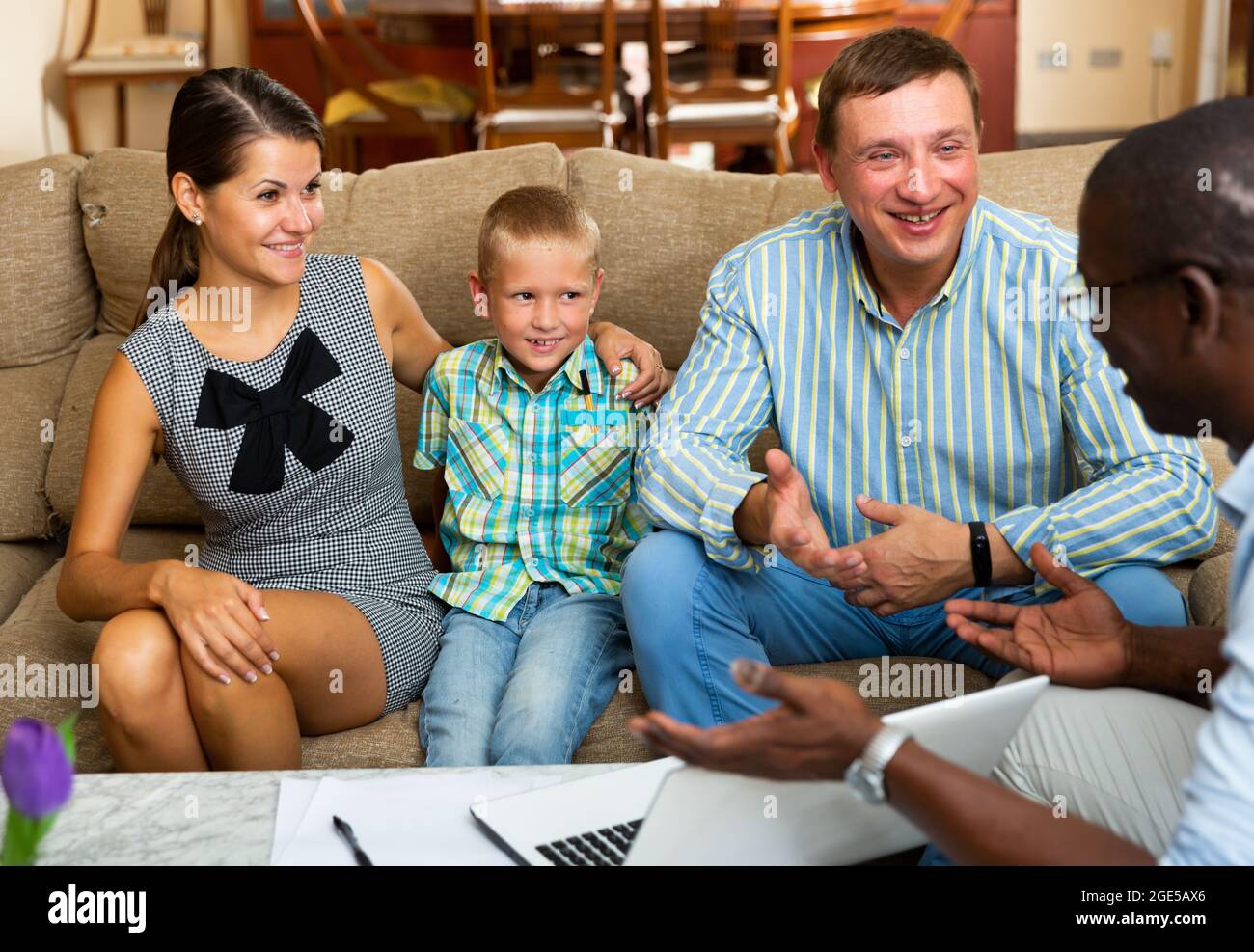 Family and insurance agent discussing contract Stock Photo - Alamy