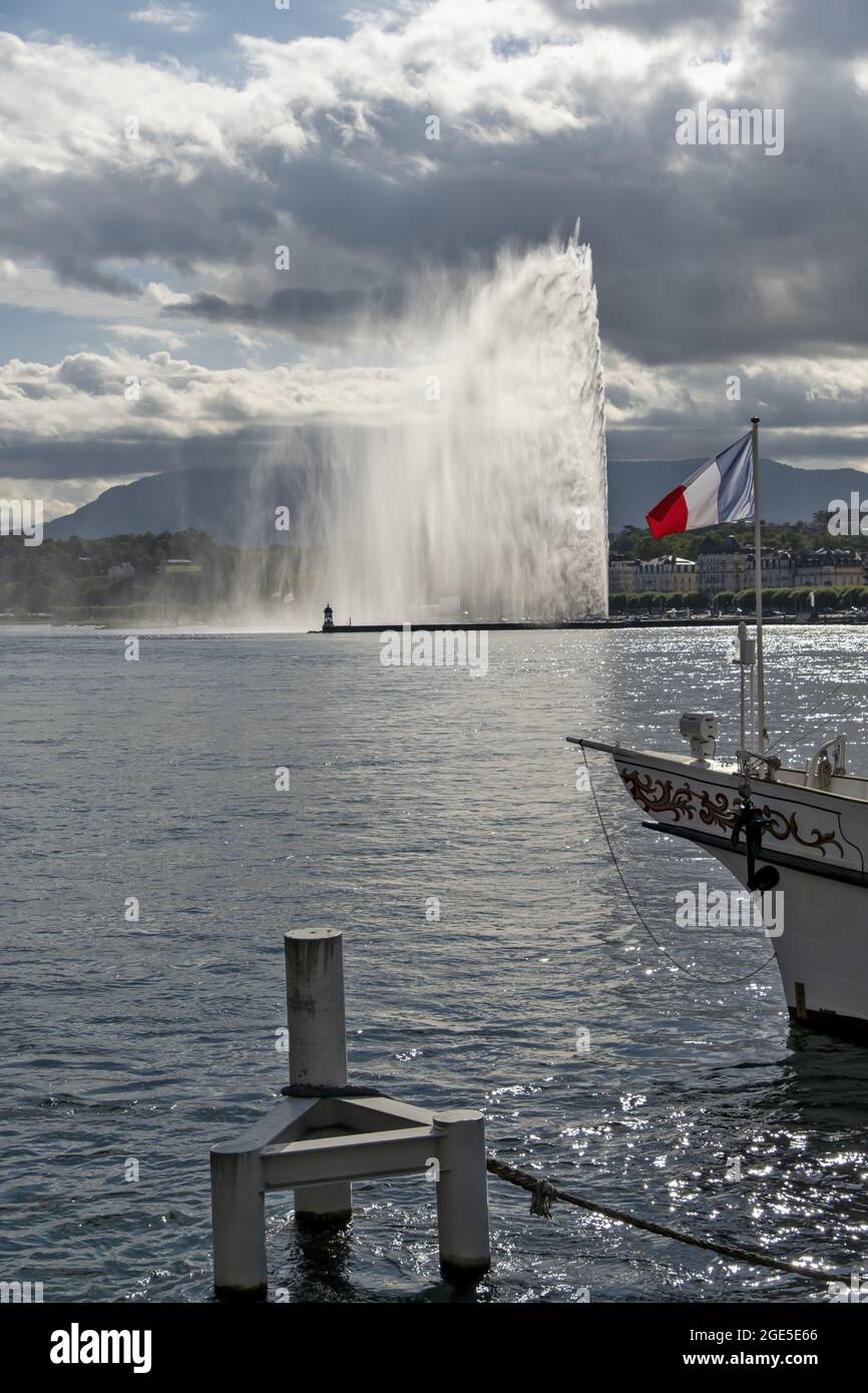 Geneva skyline with steamboat and famous water jet fountain and Geneva ...