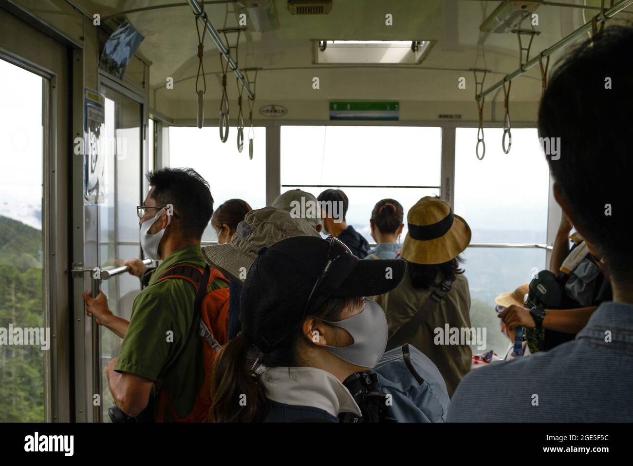 Nagano, Japan, 2021-10-08 , people inside the ropeway cabin at Tsugaike ...