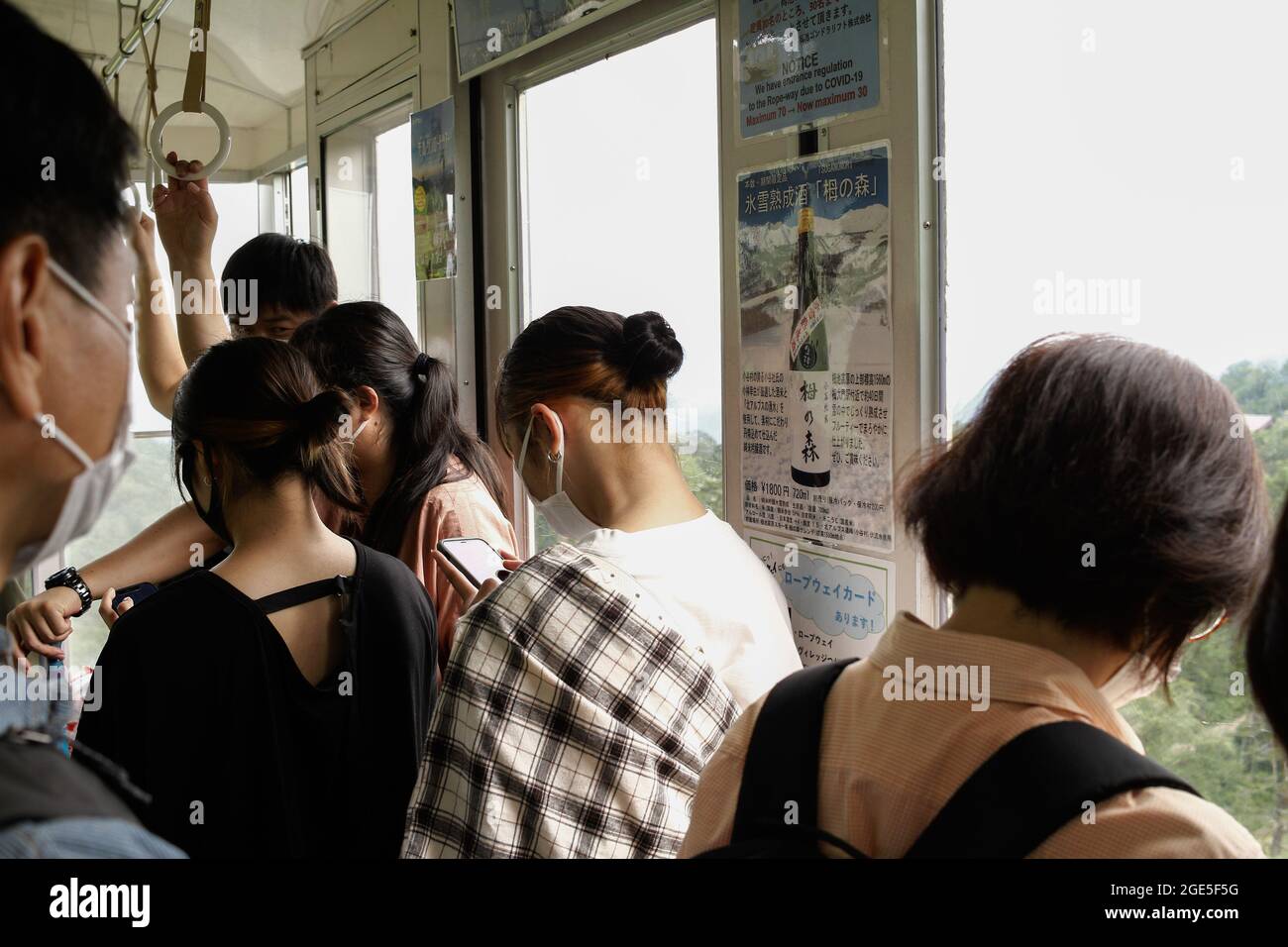Nagano, Japan, 2021-10-08 , people inside the ropeway cabin at Tsugaike ...