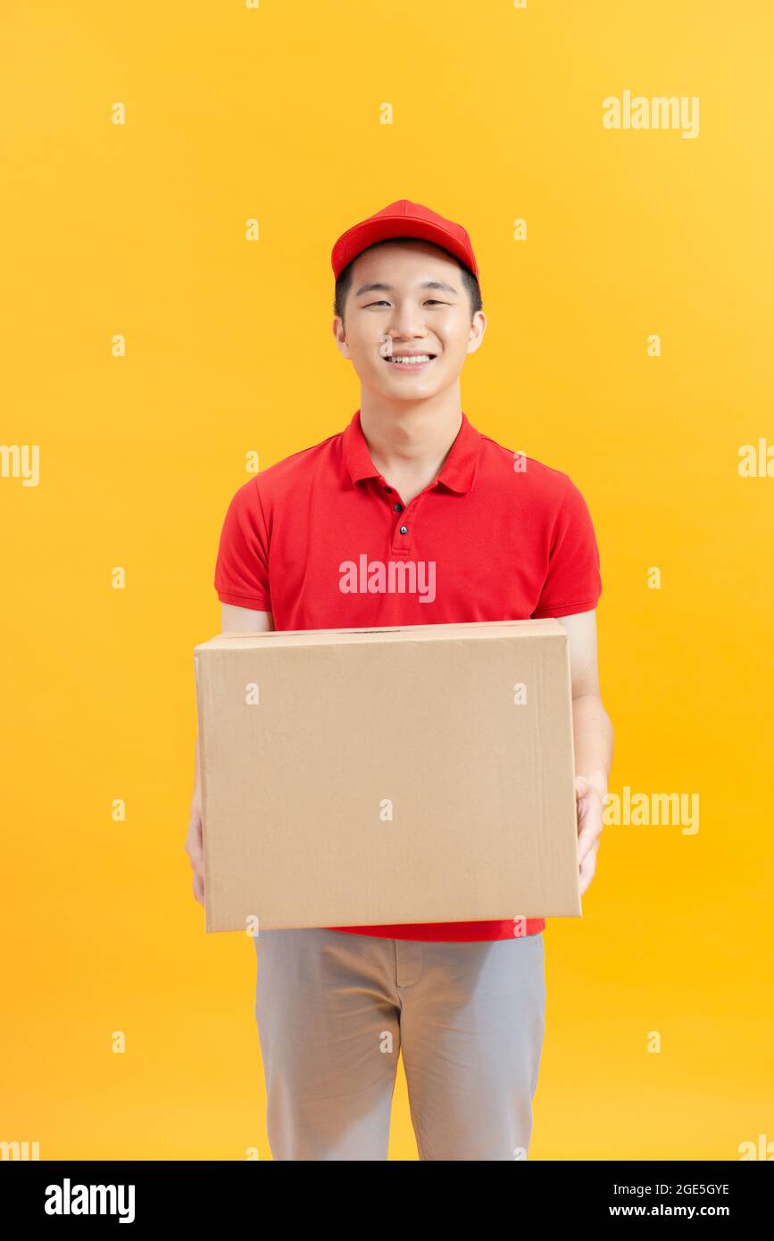 delivery man with box isolated over color Stock Photo - Alamy